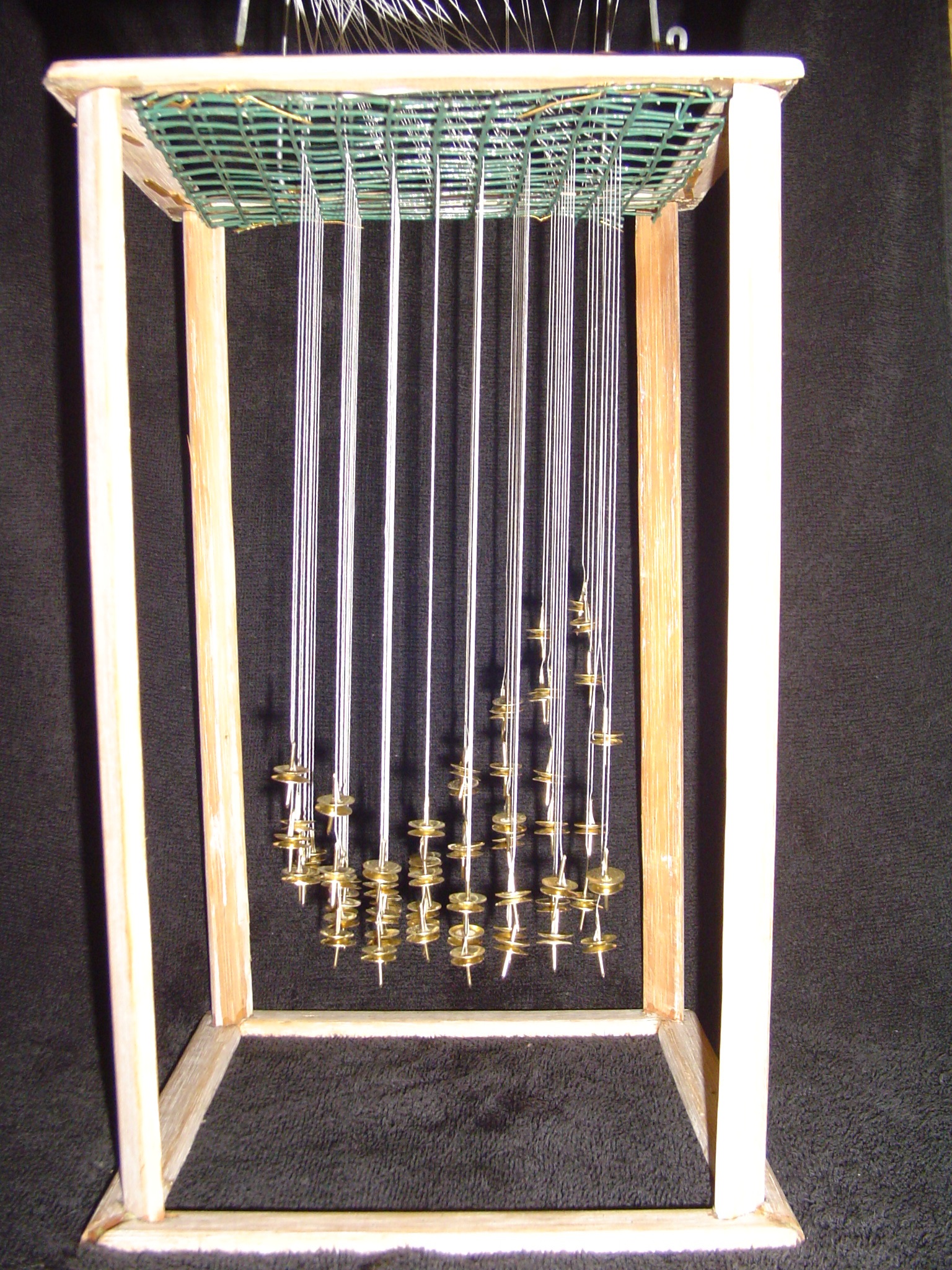 Kinetic sculpture of water ripple, using pins and thread - Bertie Pleass