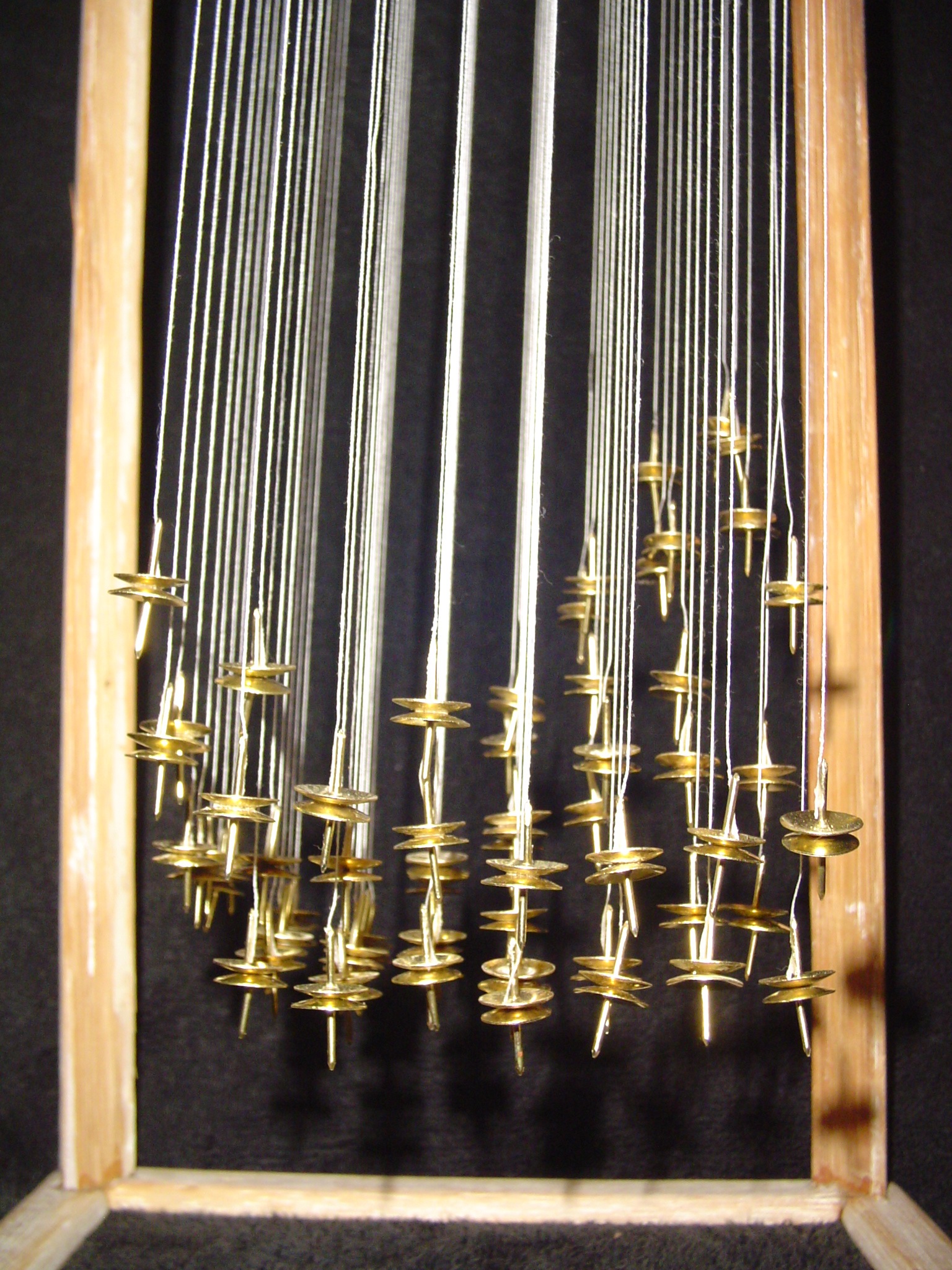 Kinetic sculpture of water ripple, using pins and thread - Bertie Pleass