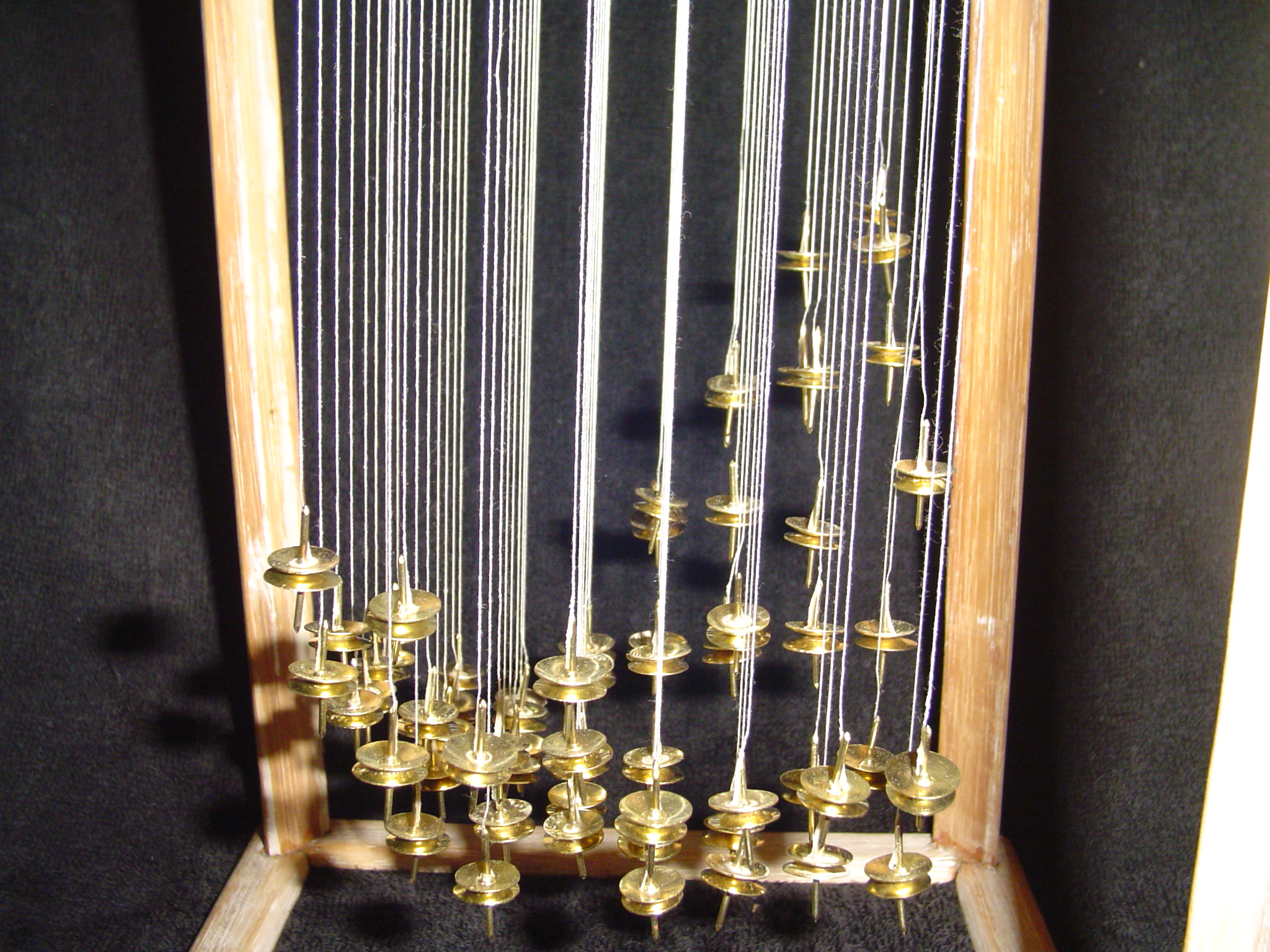 Kinetic sculpture of water ripple, using pins and thread - Bertie Pleass