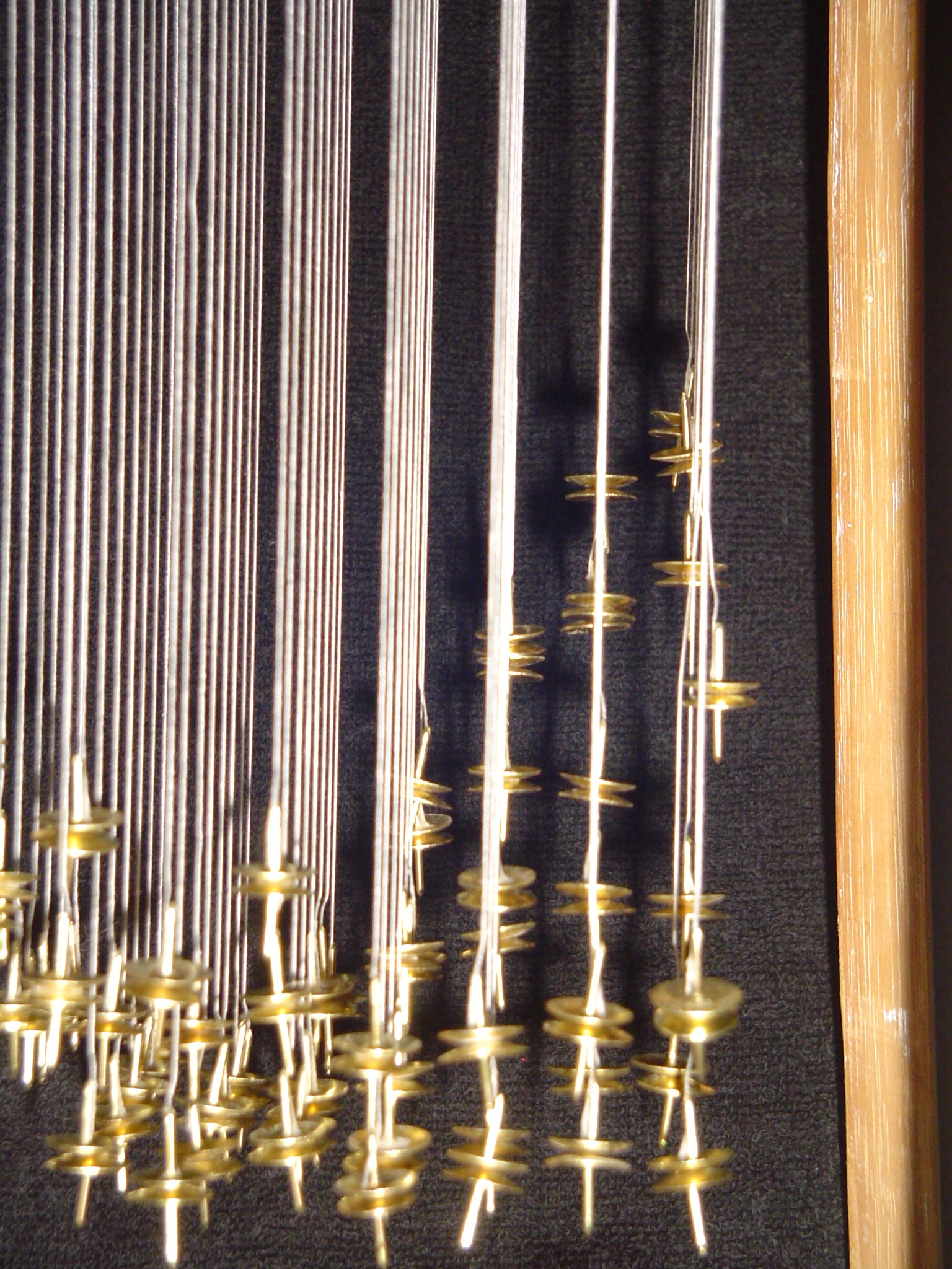Kinetic sculpture of water ripple, using pins and thread - Bertie Pleass