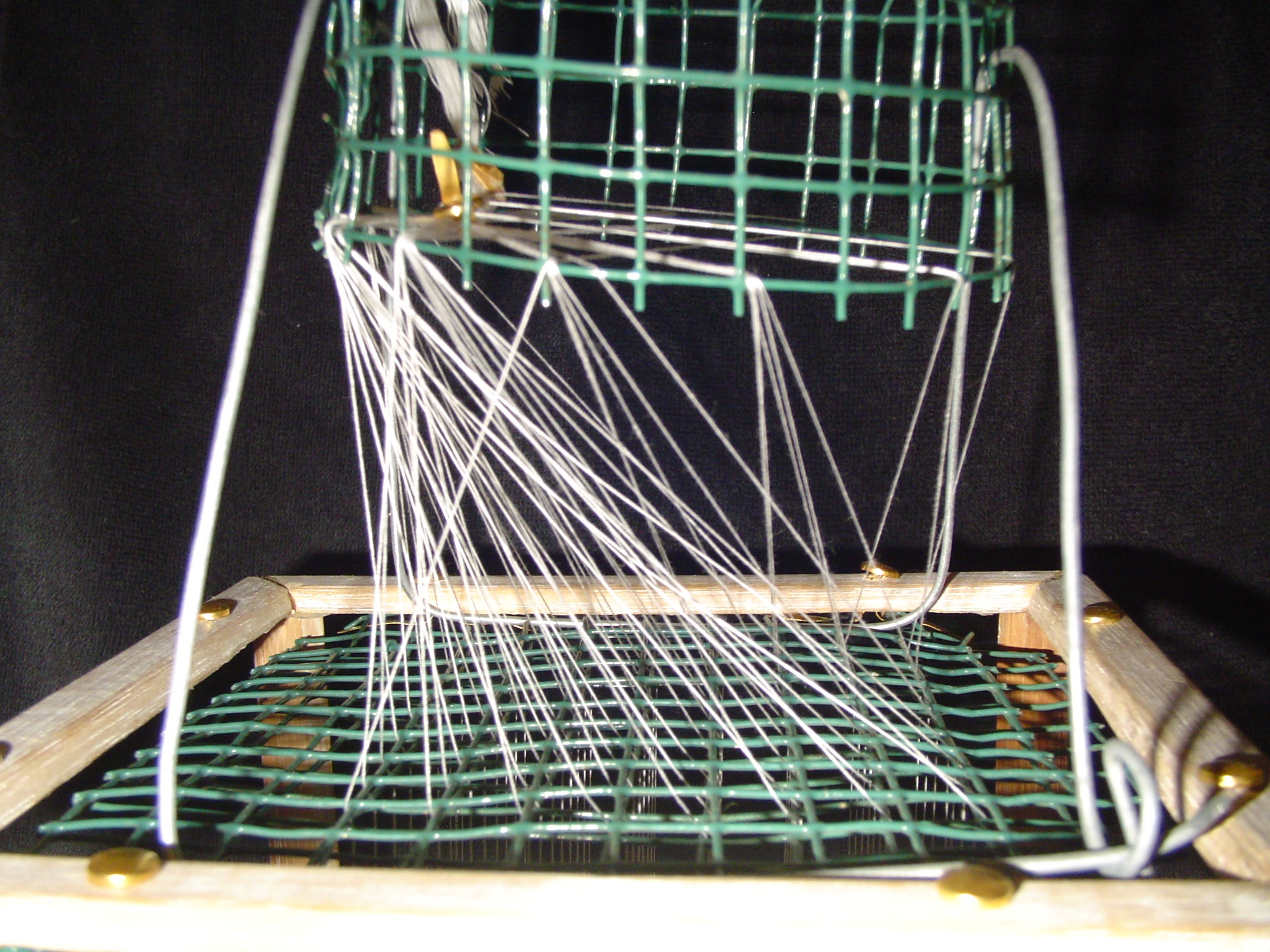 Kinetic sculpture of water ripple, using pins and thread - Bertie Pleass