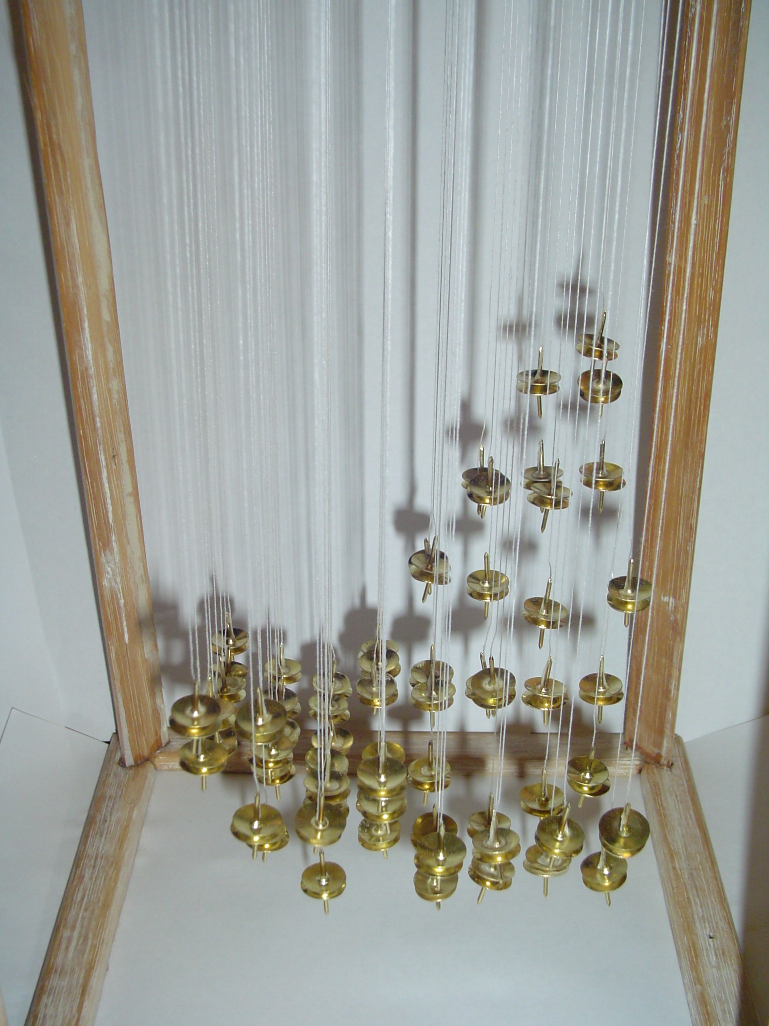 Kinetic sculpture of water ripple, using pins and thread - Bertie Pleass