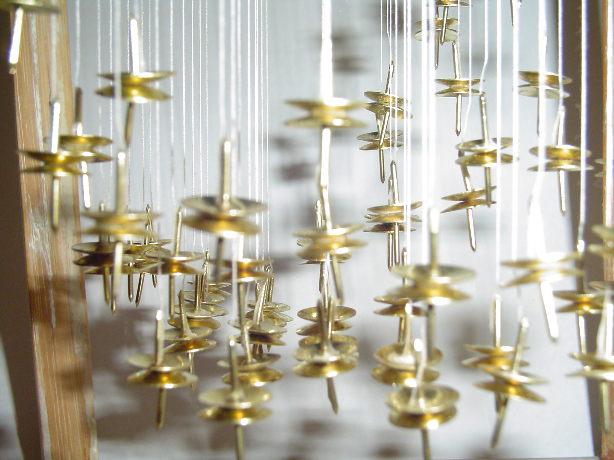 Kinetic sculpture of water ripple, using pins and thread - Bertie Pleass