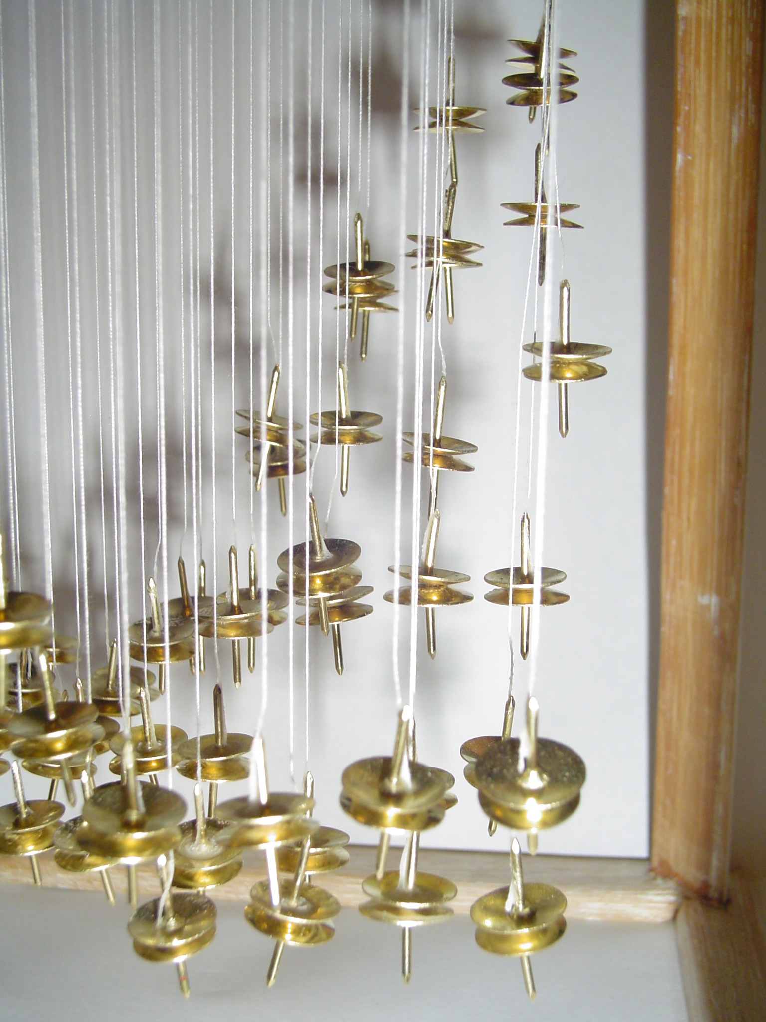 Kinetic sculpture of water ripple, using pins and thread - Bertie Pleass